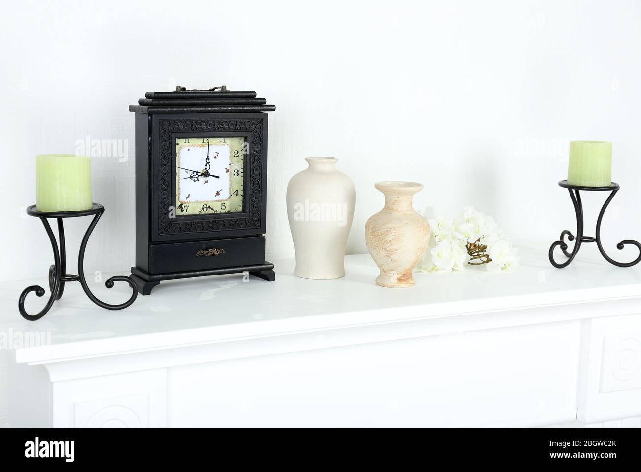 Different objects on white shelf in living room Stock Photo - Alamy