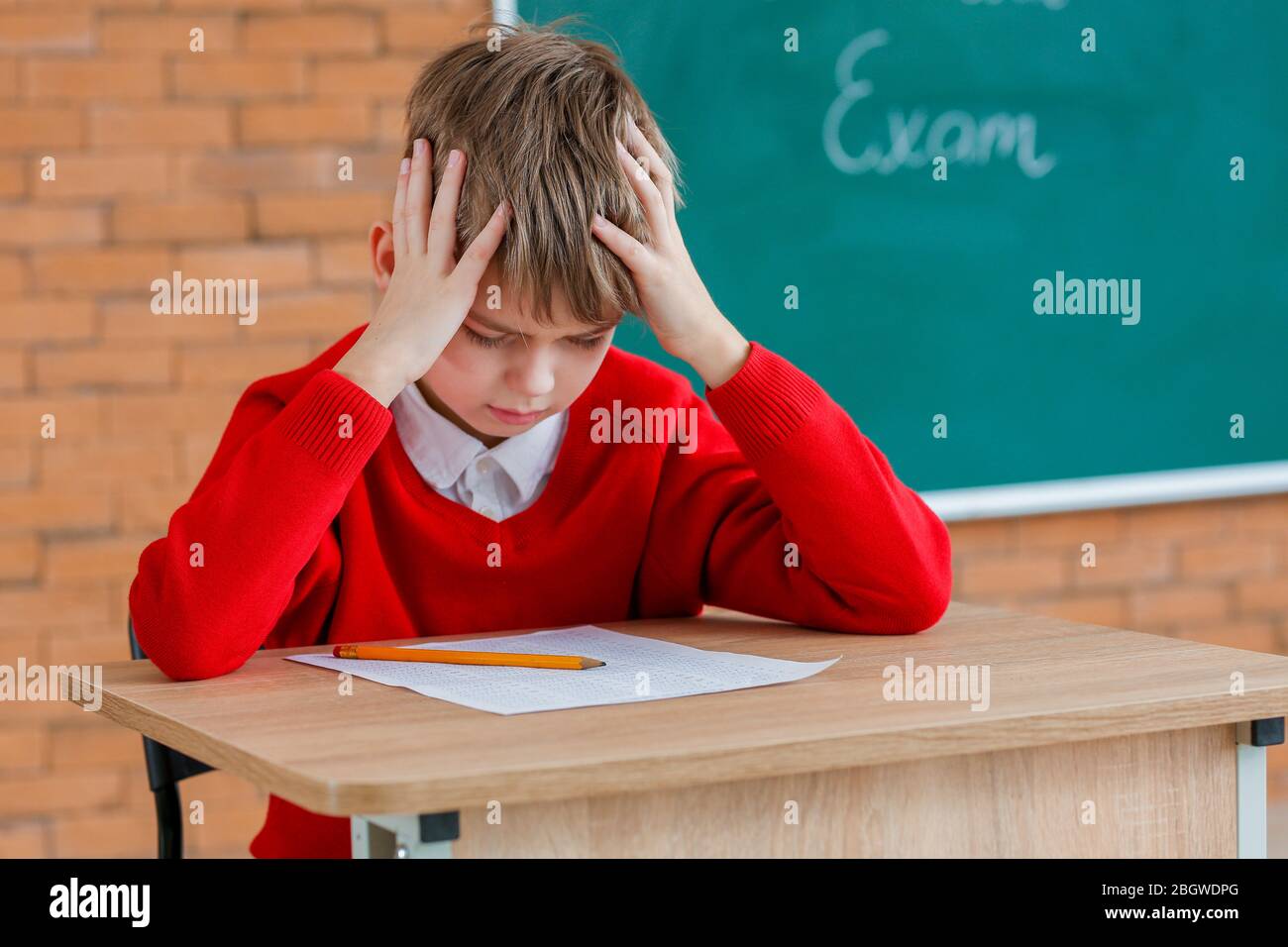 Stressed pupil passing exam at school Stock Photo - Alamy
