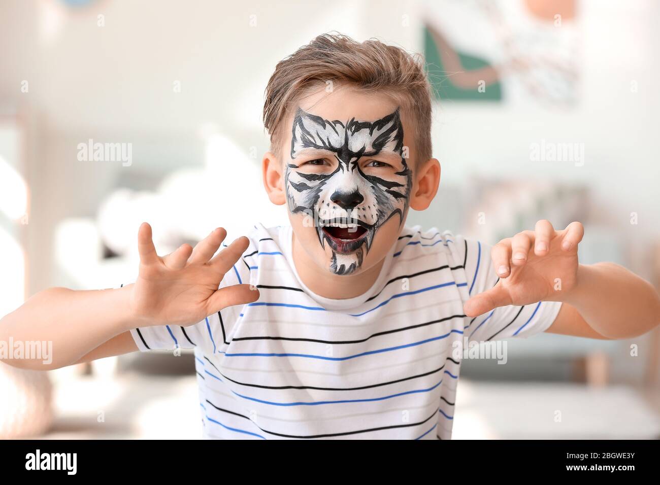 Funny little boy with face painting at home Stock Photo - Alamy