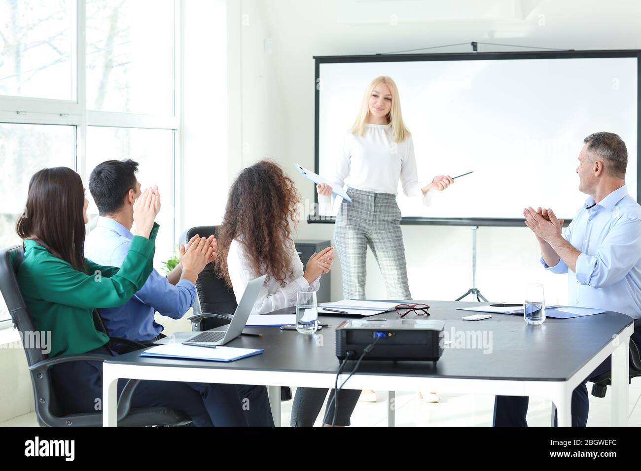 Businesswoman giving presentation during meeting in office Stock Photo ...