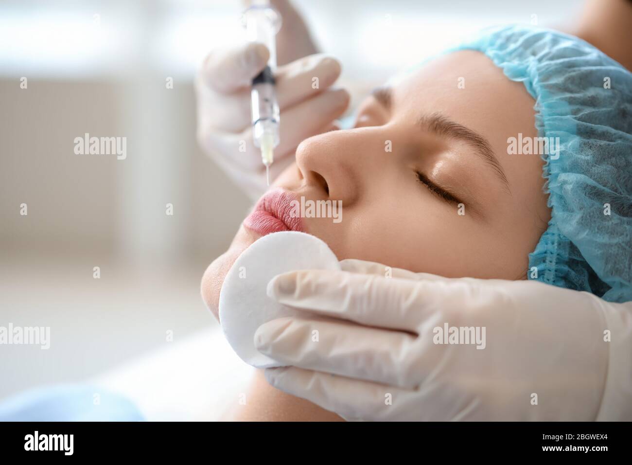 Young woman receiving filler injection in beauty salon Stock Photo - Alamy