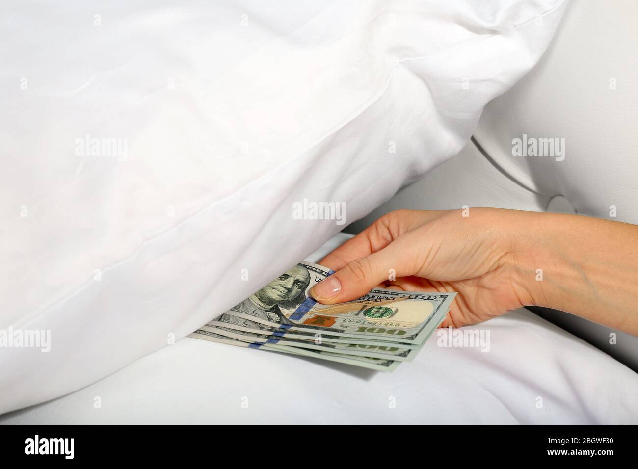 Woman hiding money bed hi-res stock photography and images - Alamy