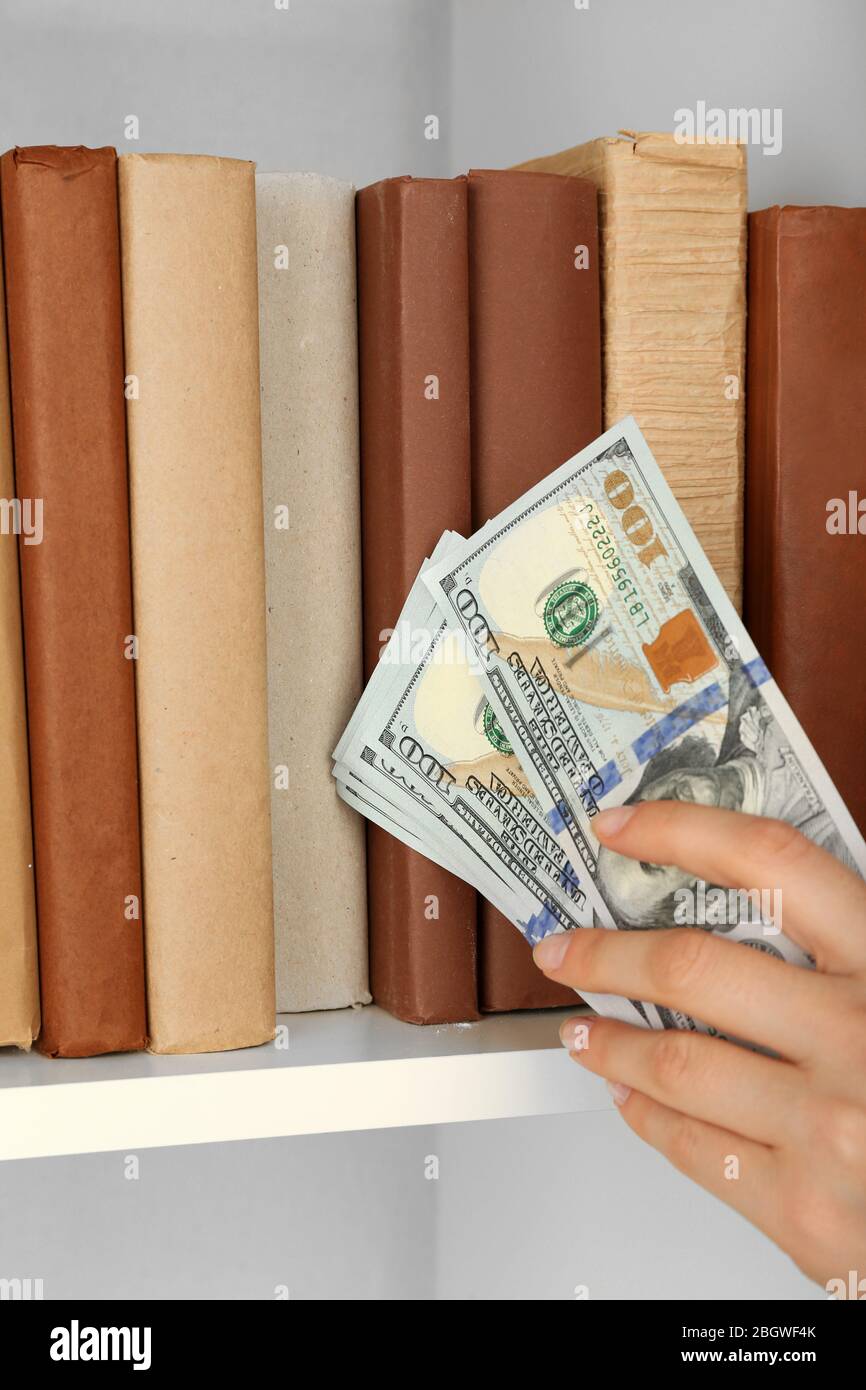 Book shelf and money hi-res stock photography and images - Alamy