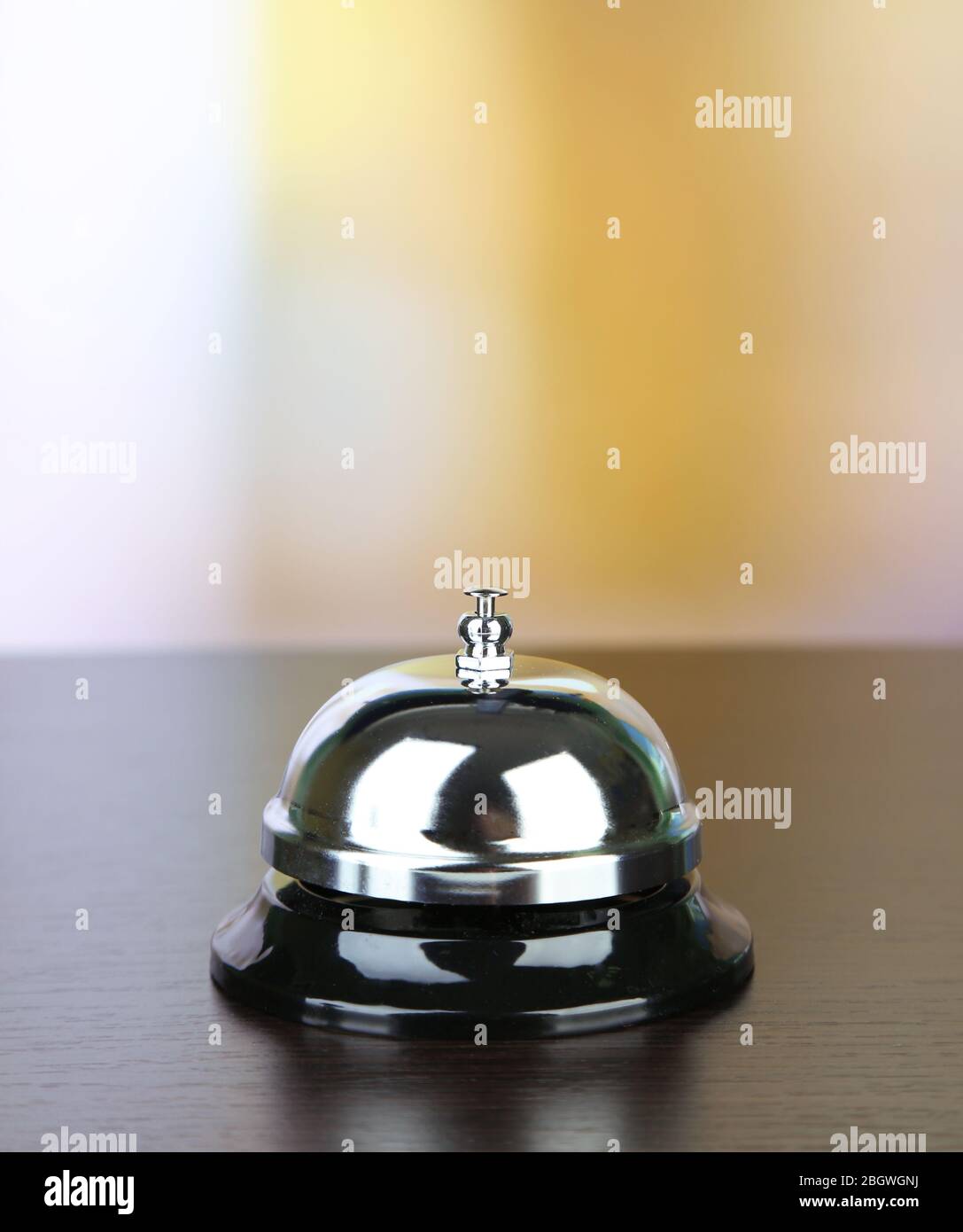 Reception bell on desk, on bright background Stock Photo - Alamy
