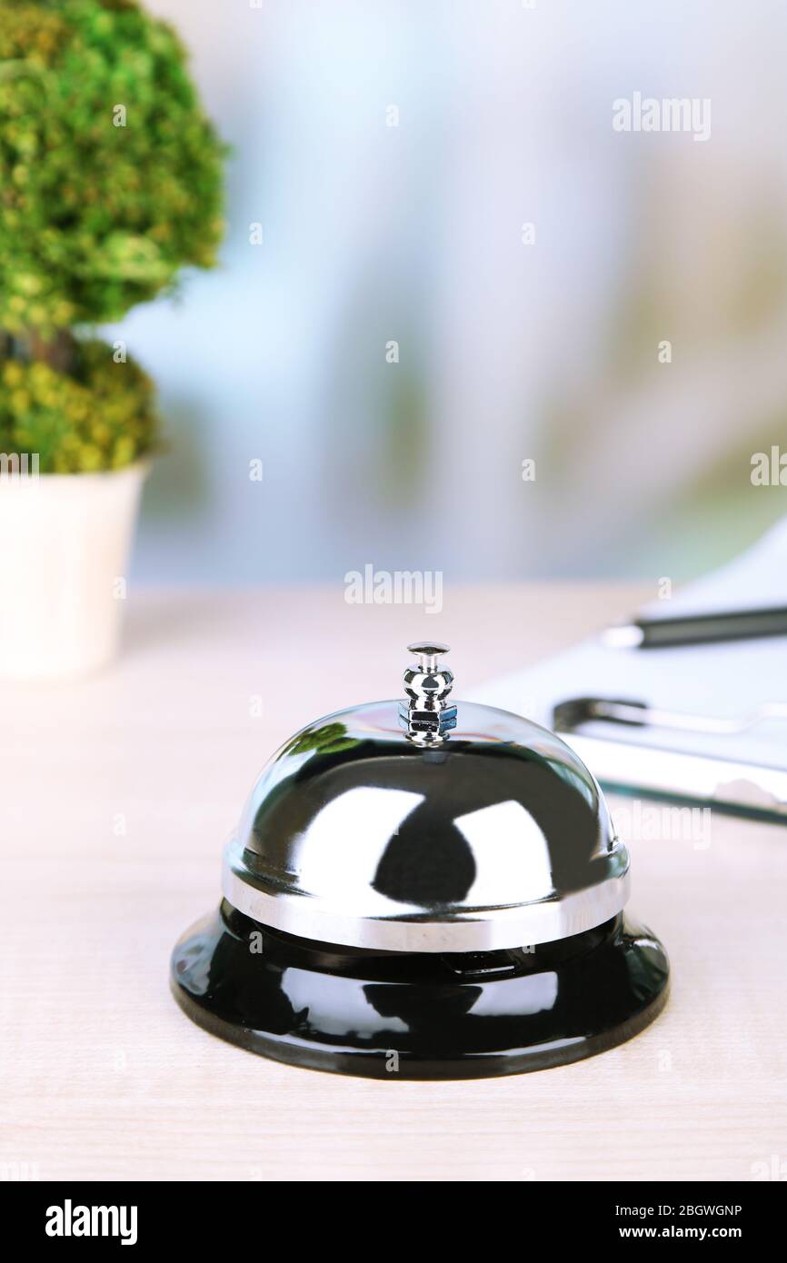 Reception bell on desk, on bright background Stock Photo - Alamy