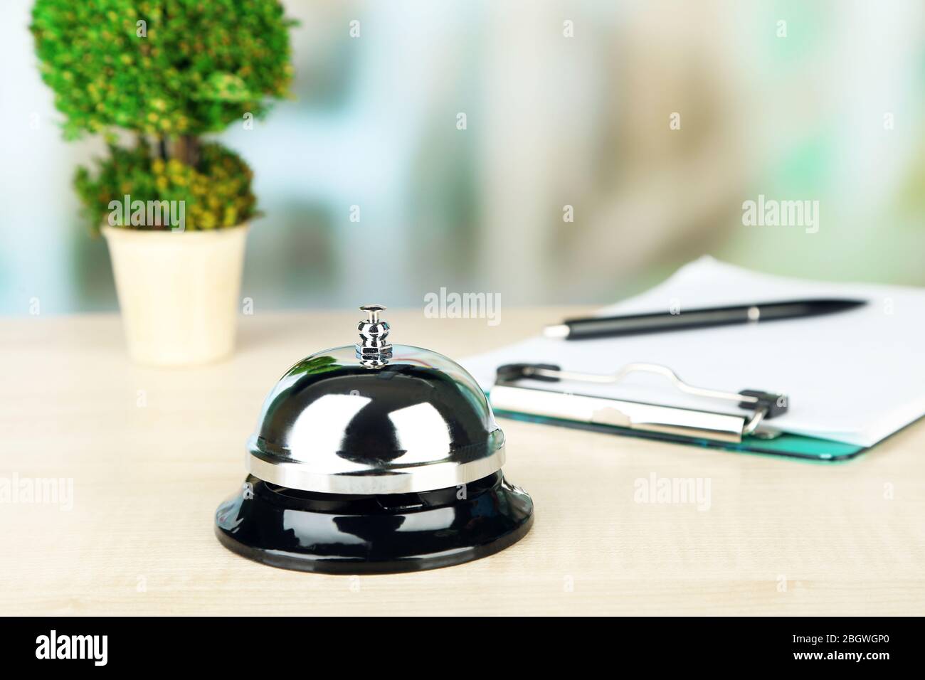 Reception bell on desk, on bright background Stock Photo - Alamy