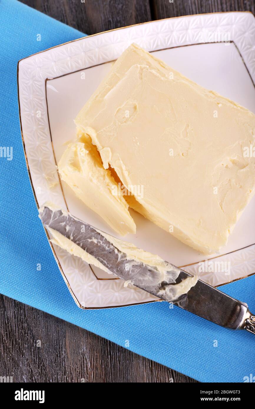 Fresh butter on plate, on wooden background Stock Photo - Alamy