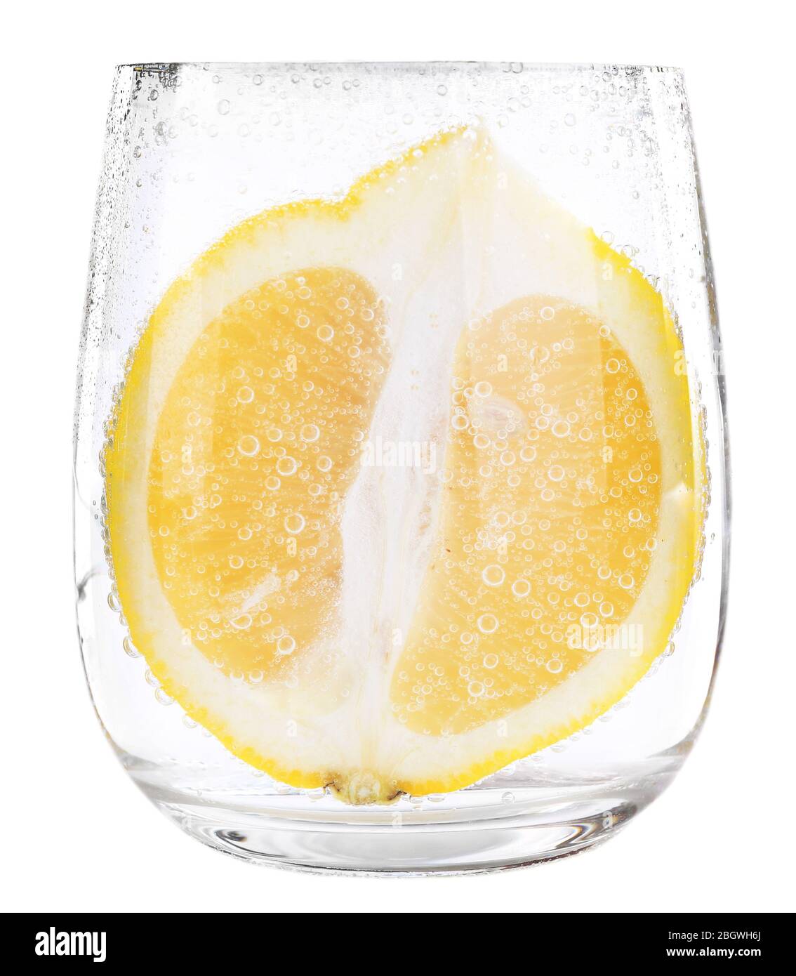 Lemon in glass of water isolated on white Stock Photo - Alamy