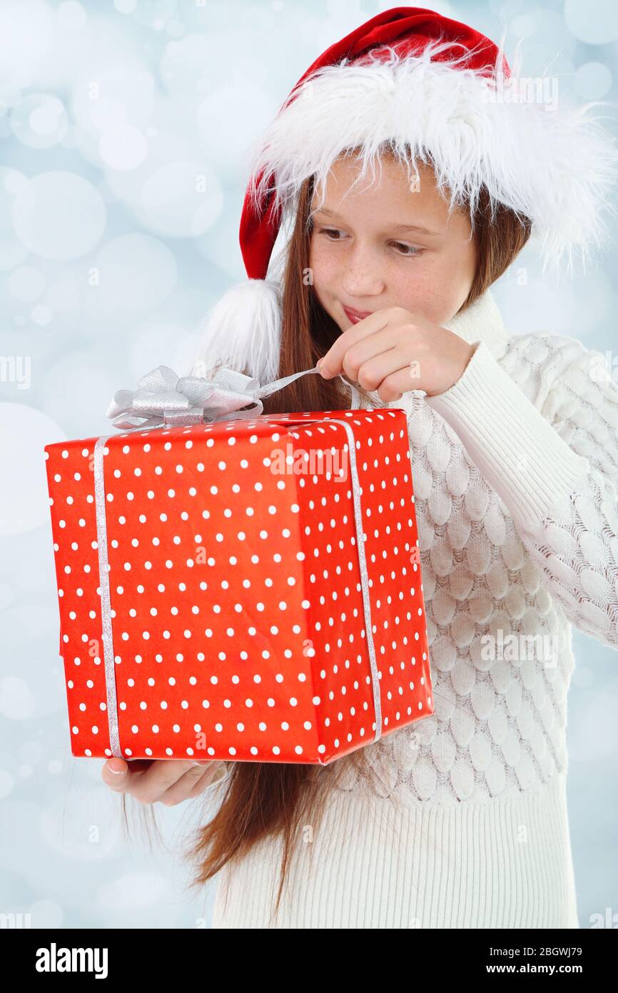 Beautiful little girl with present box on bright background Stock Photo ...