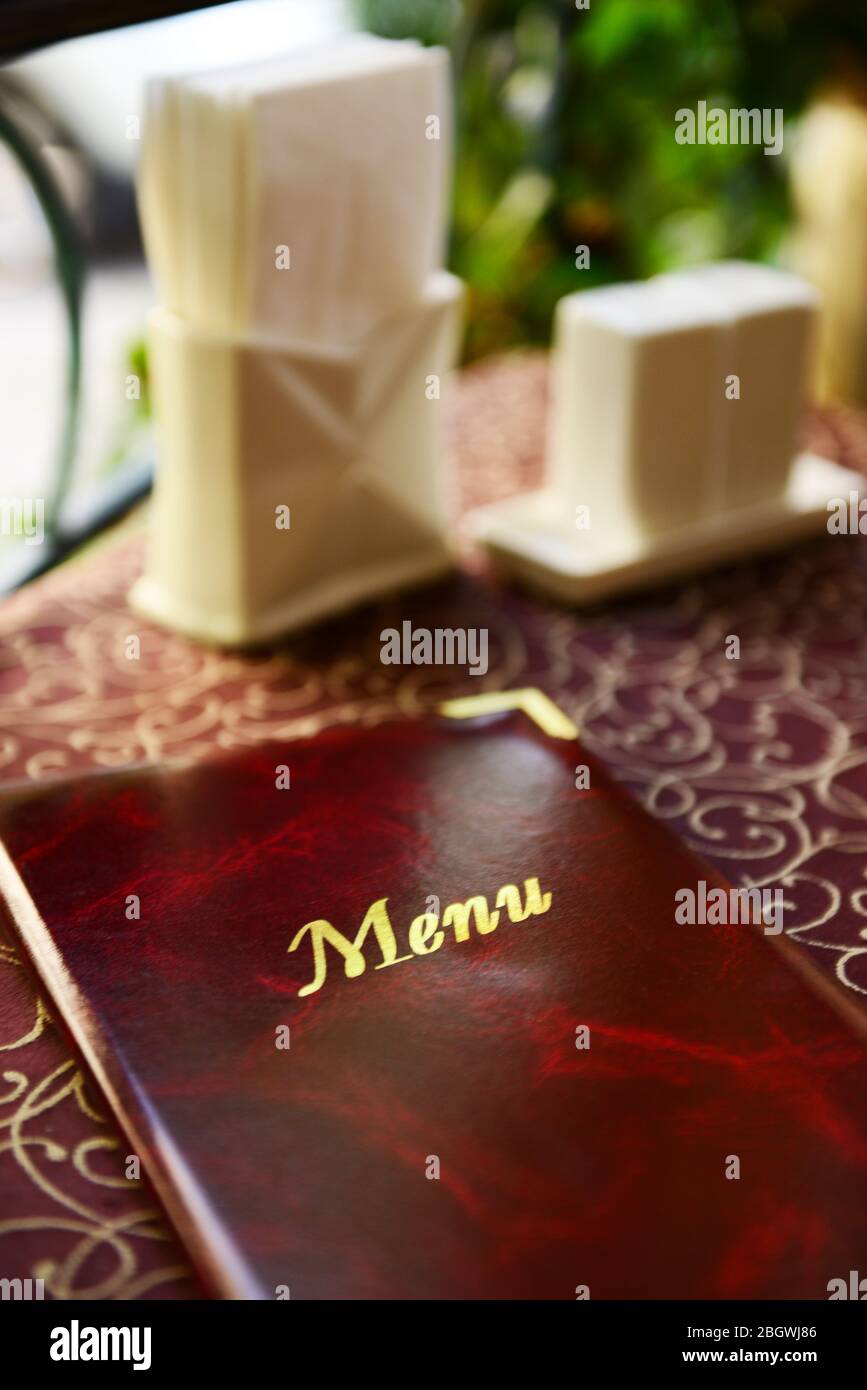 Menu book on table in restaurant Stock Photo - Alamy