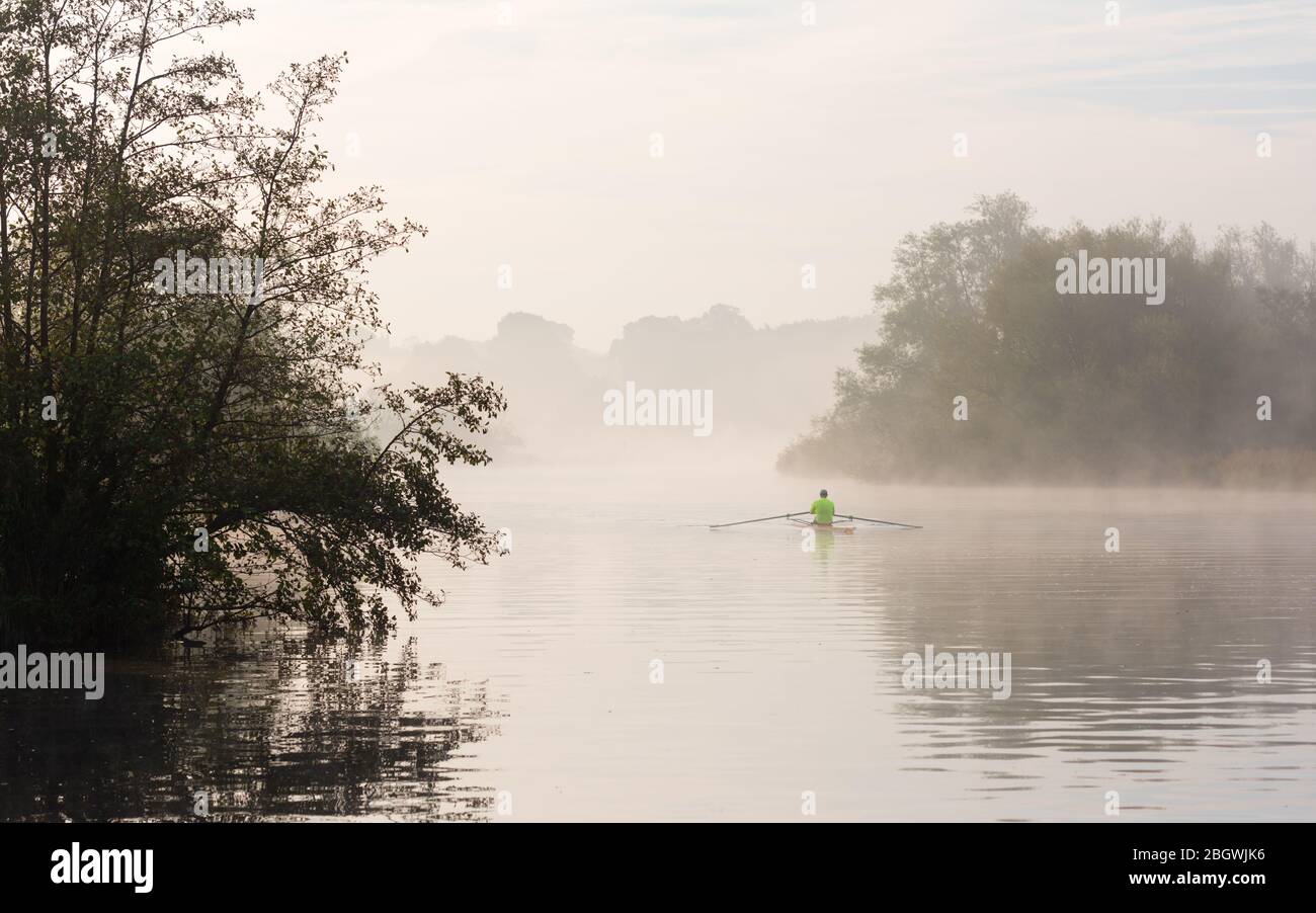 Single sculling rowing boat on misty river i. October, 2018 Stock Photo ...