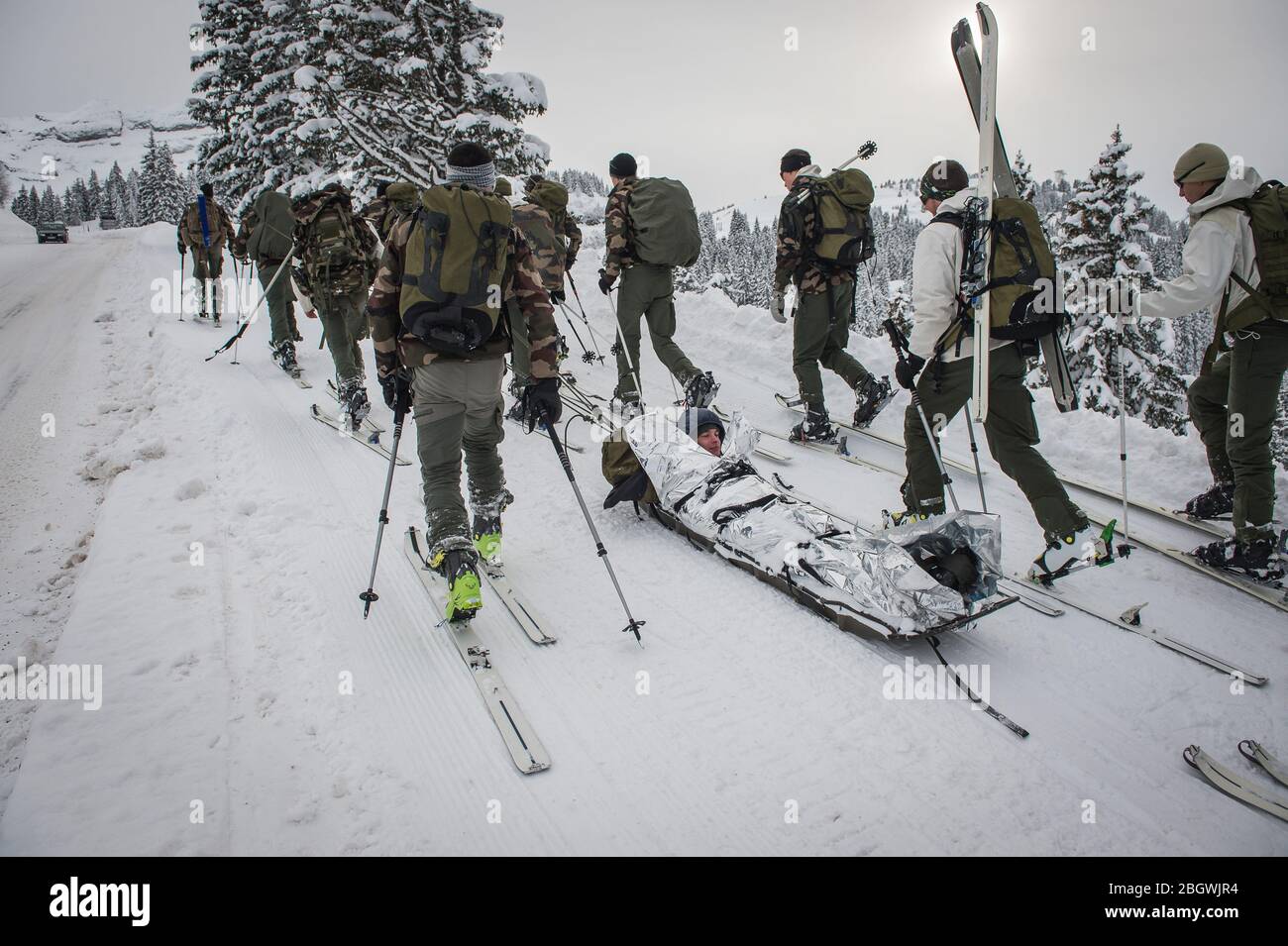 CHAMONIX, FRANCE - FEBRUARY 03: soldiers rescuing a man during a ski ...