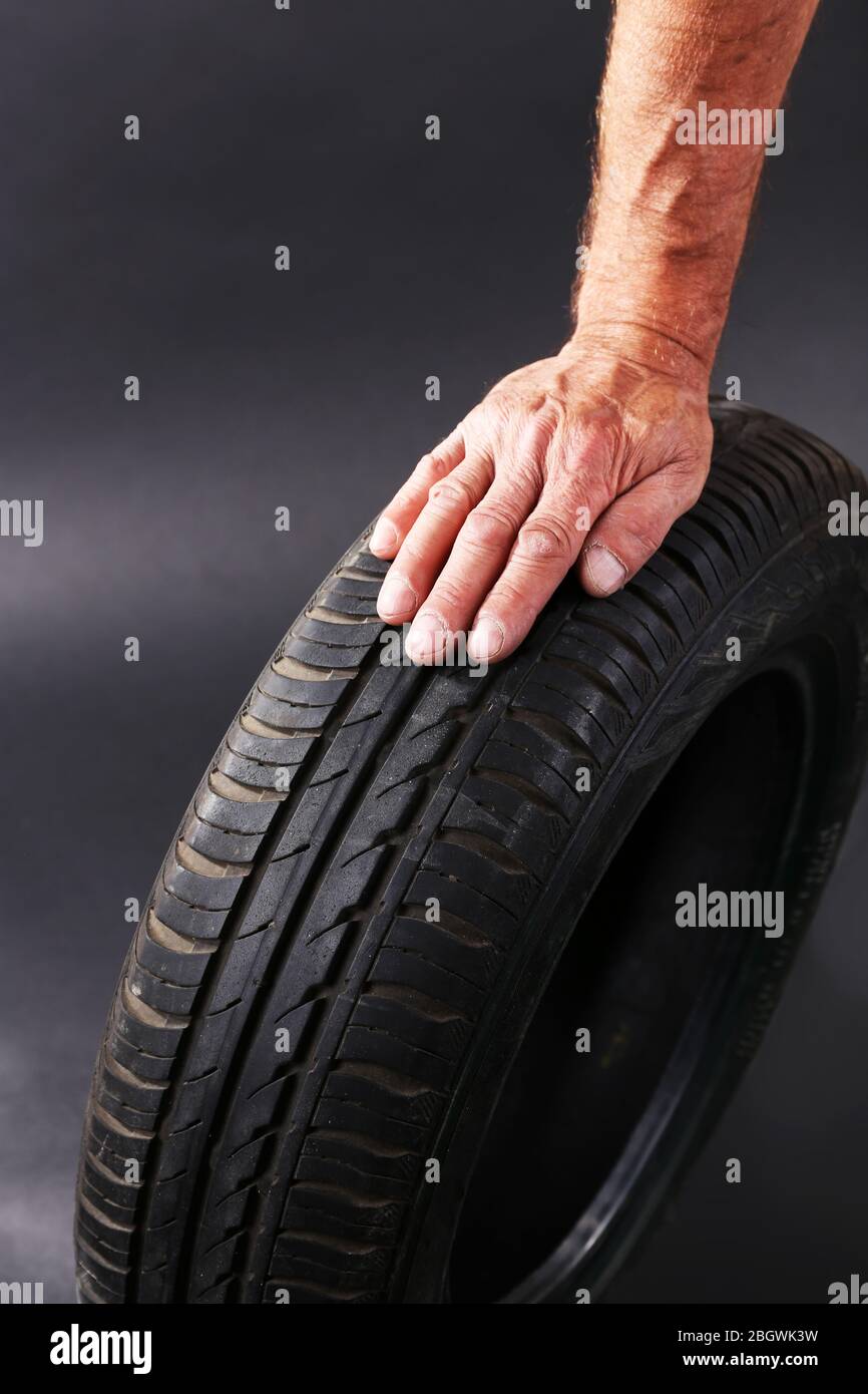 Hand holding tyre hi-res stock photography and images - Alamy