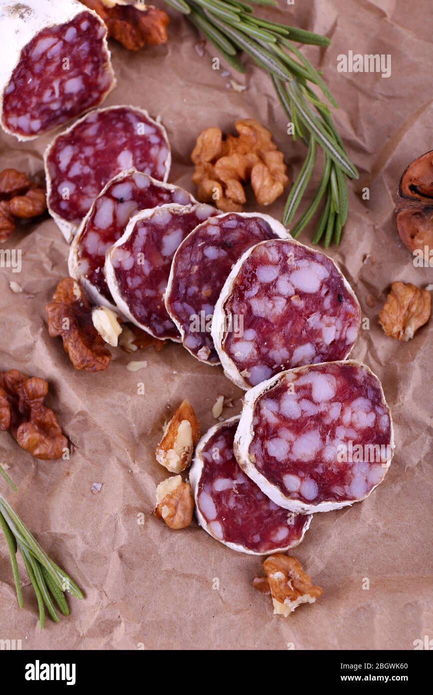 French salami and walnuts on craft paper background Stock Photo - Alamy