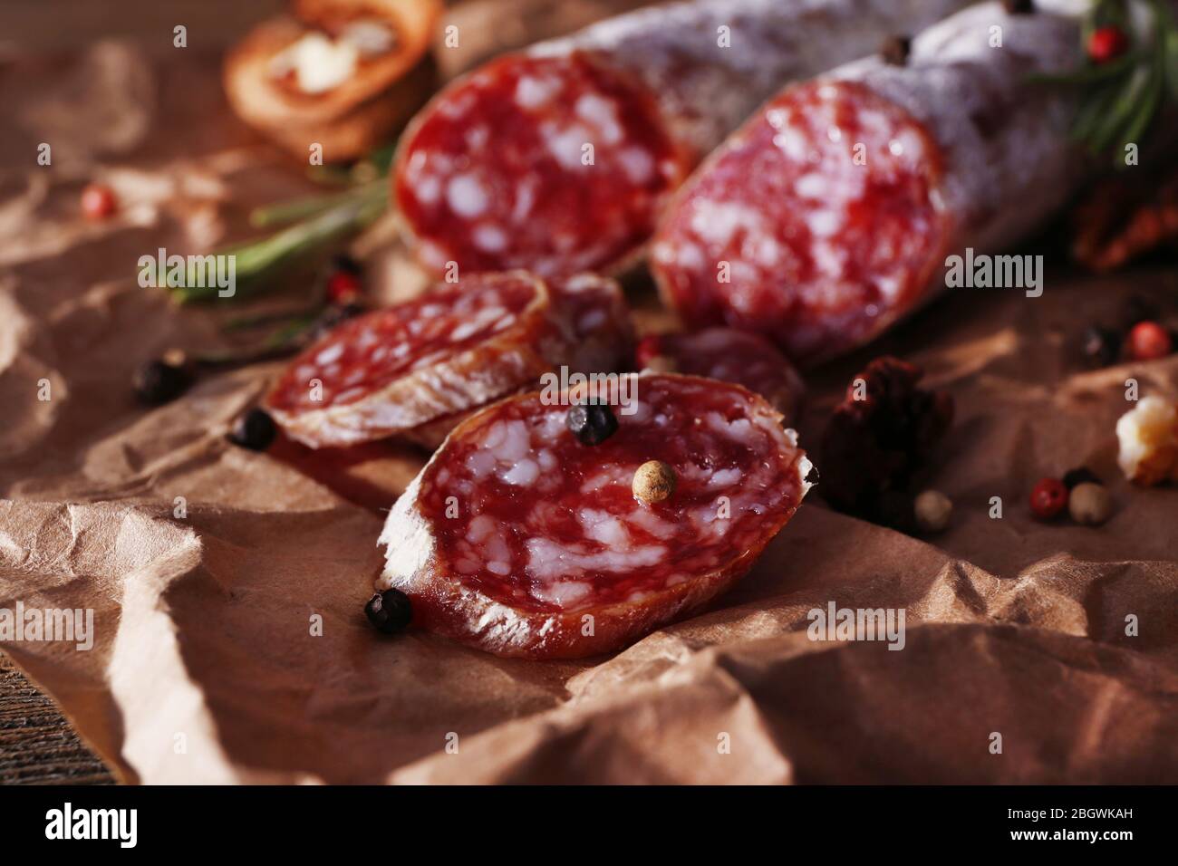 French salami and walnuts on craft paper background Stock Photo - Alamy