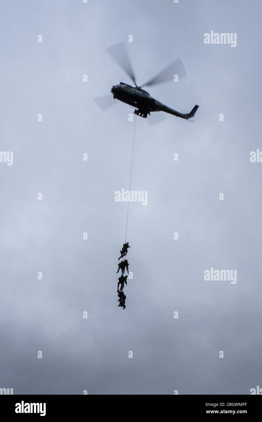 Hanging from helicopter hi-res stock photography and images - Alamy