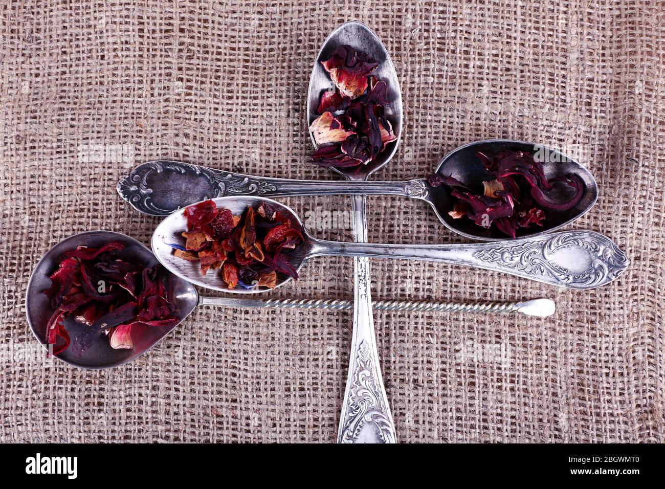 Tea in spoons on sackcloth fabric background Stock Photo - Alamy