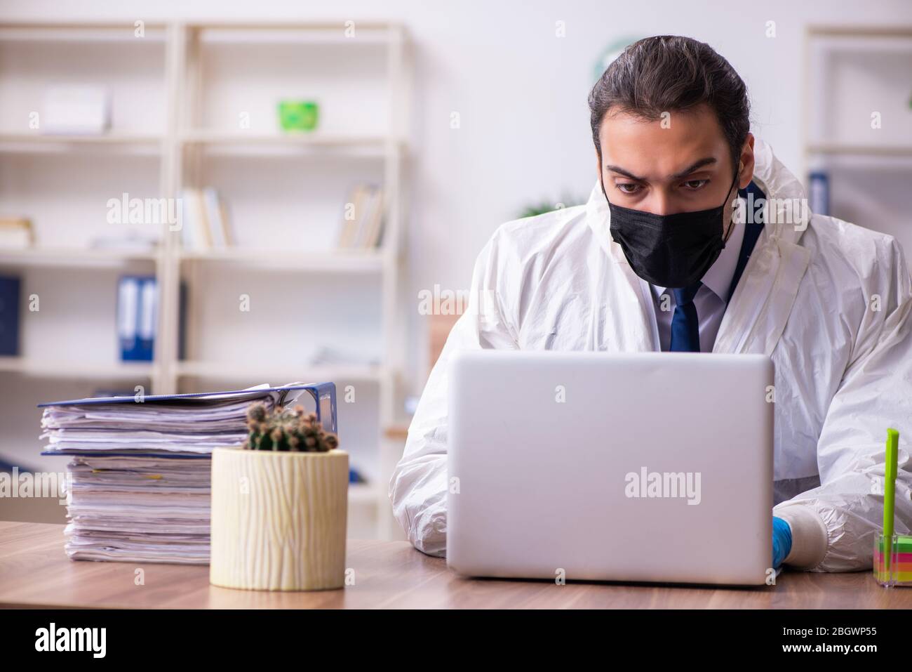Young male employee in the self-isolation concept Stock Photo - Alamy