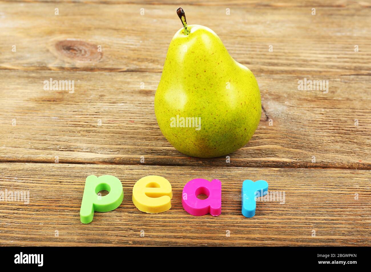 Pear word formed with colorful letters on wooden background Stock Photo ...