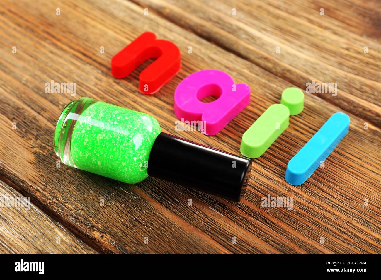 Nail word formed with colorful letters on wooden background Stock Photo ...