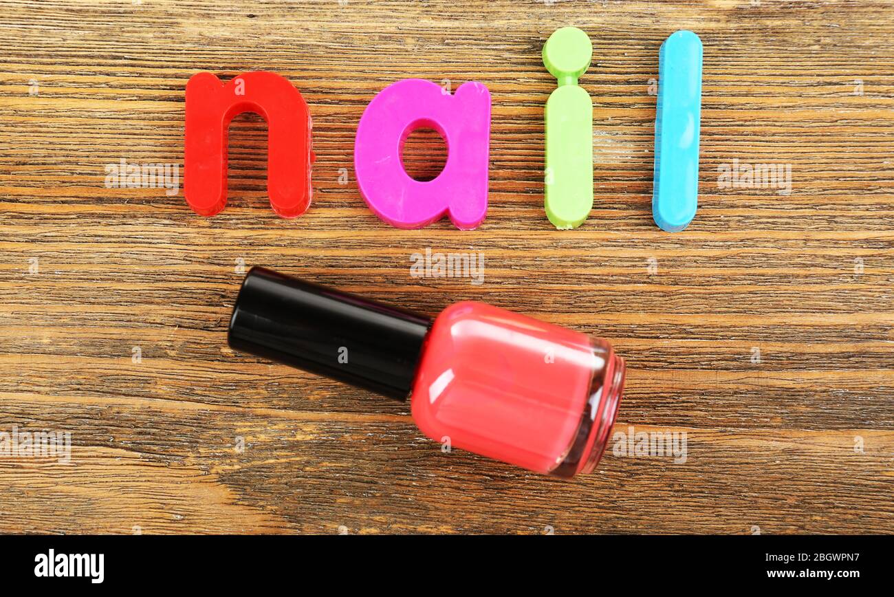 Nail word formed with colorful letters on wooden background Stock Photo ...