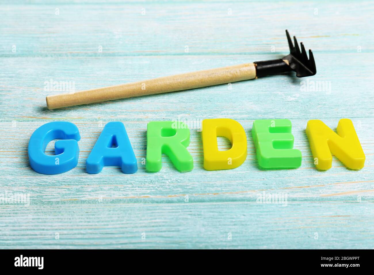 Garden word formed with colorful letters on wooden background Stock ...