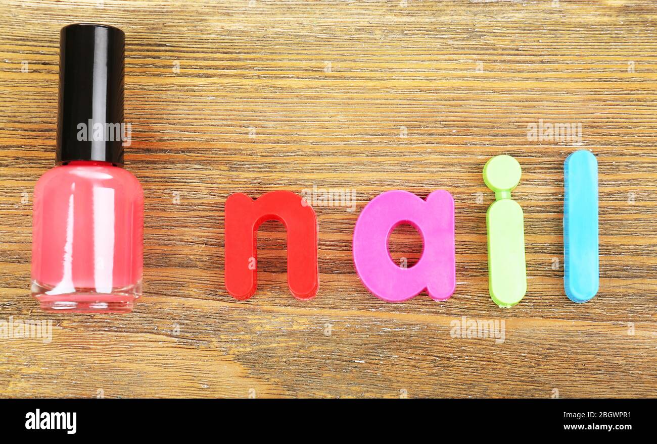 Nail word formed with colorful letters on wooden background Stock Photo ...