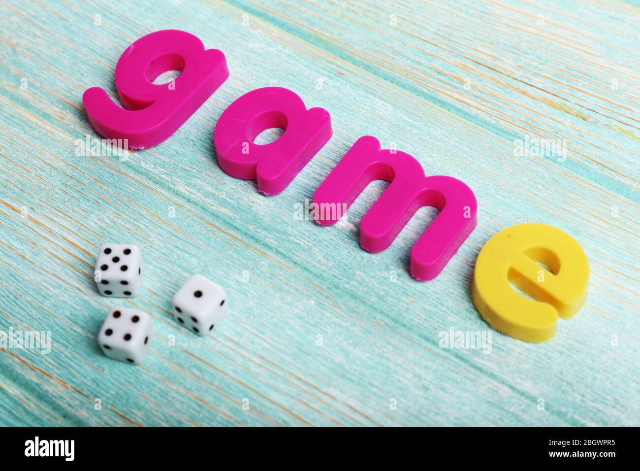 Game word formed with colorful letters on wooden background Stock Photo ...
