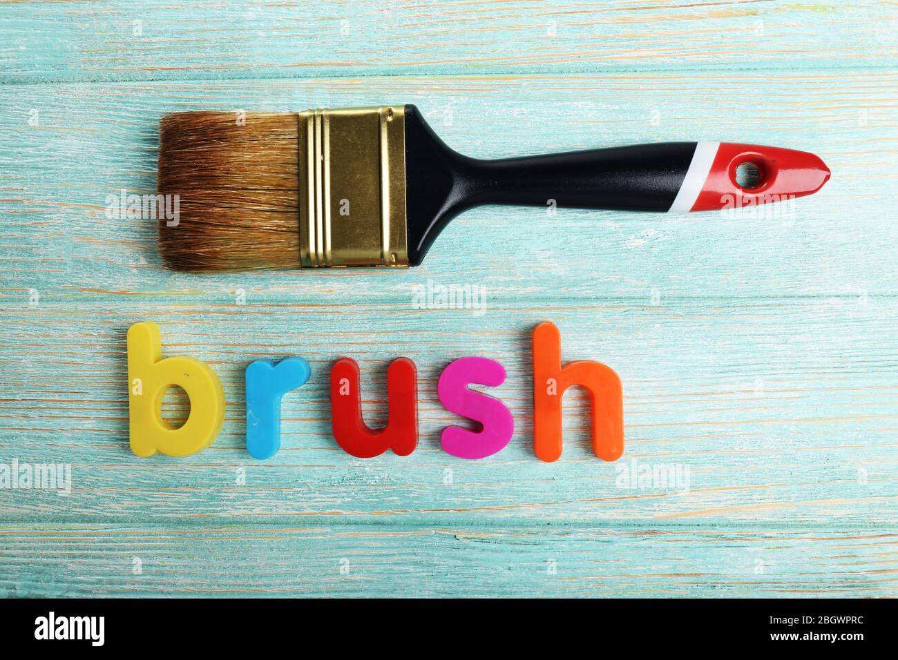 Brush word formed with colorful letters on wooden background Stock ...