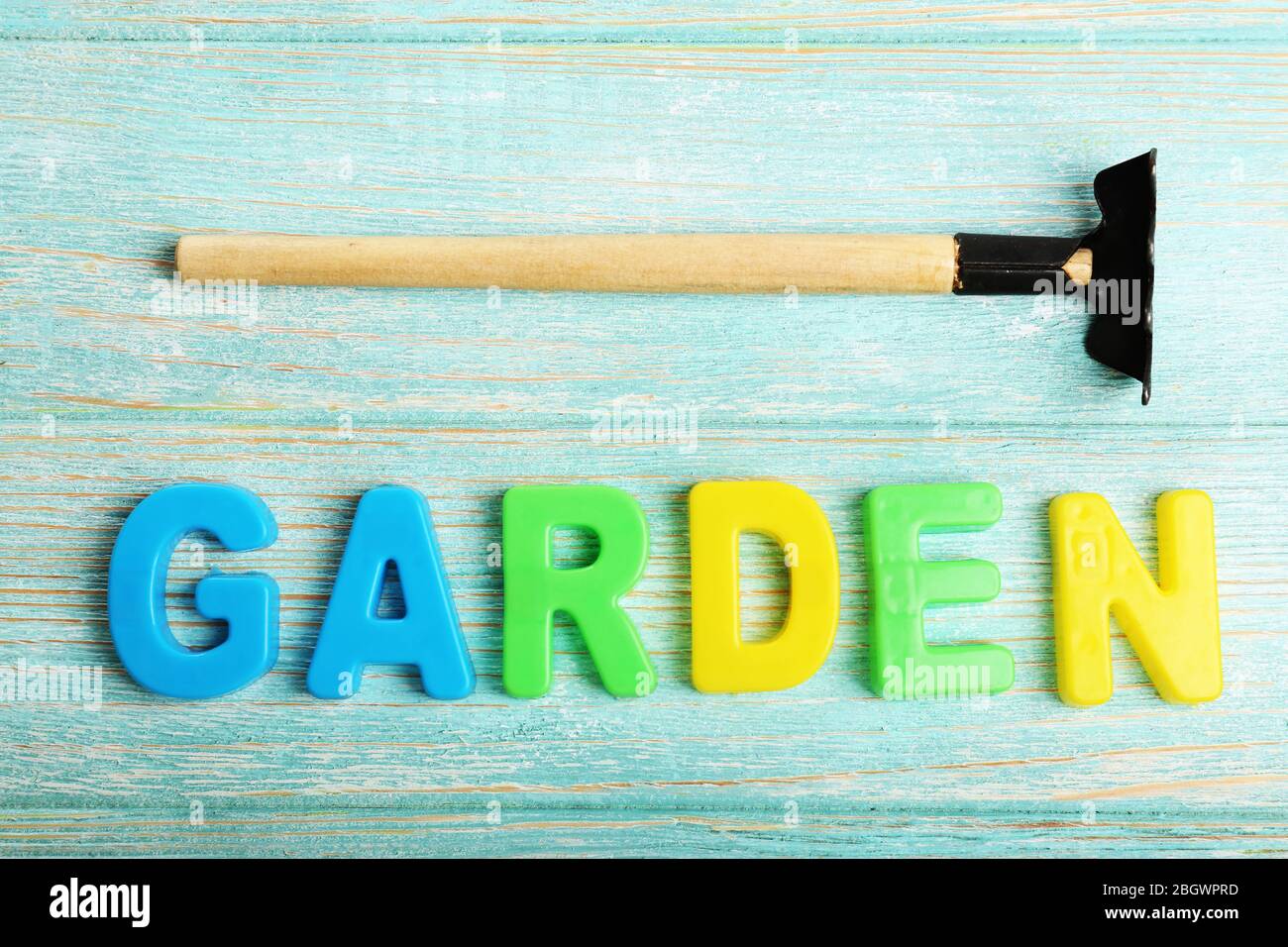 Garden word formed with colorful letters on wooden background Stock ...