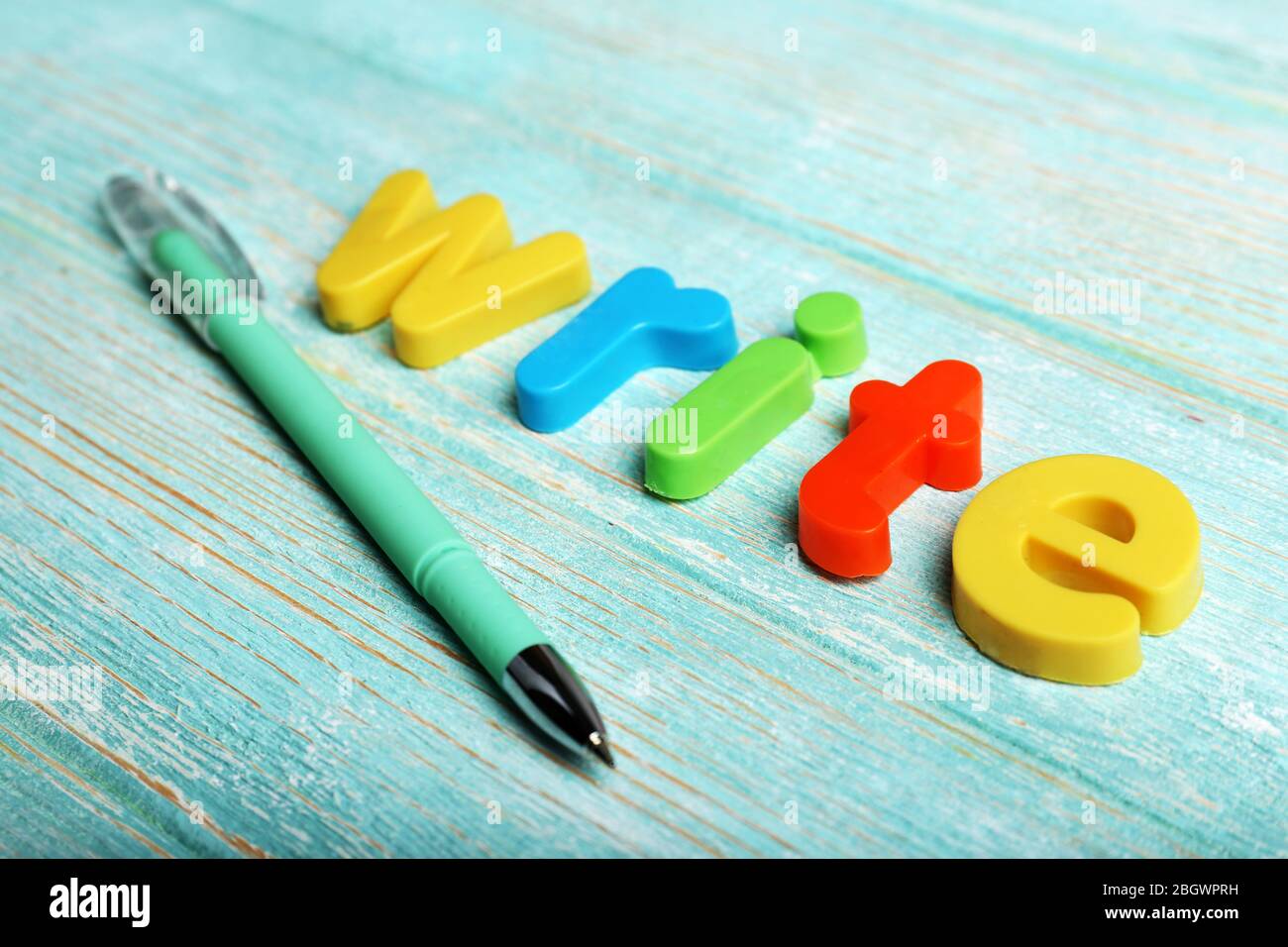 Write word formed with colorful letters on wooden background Stock ...