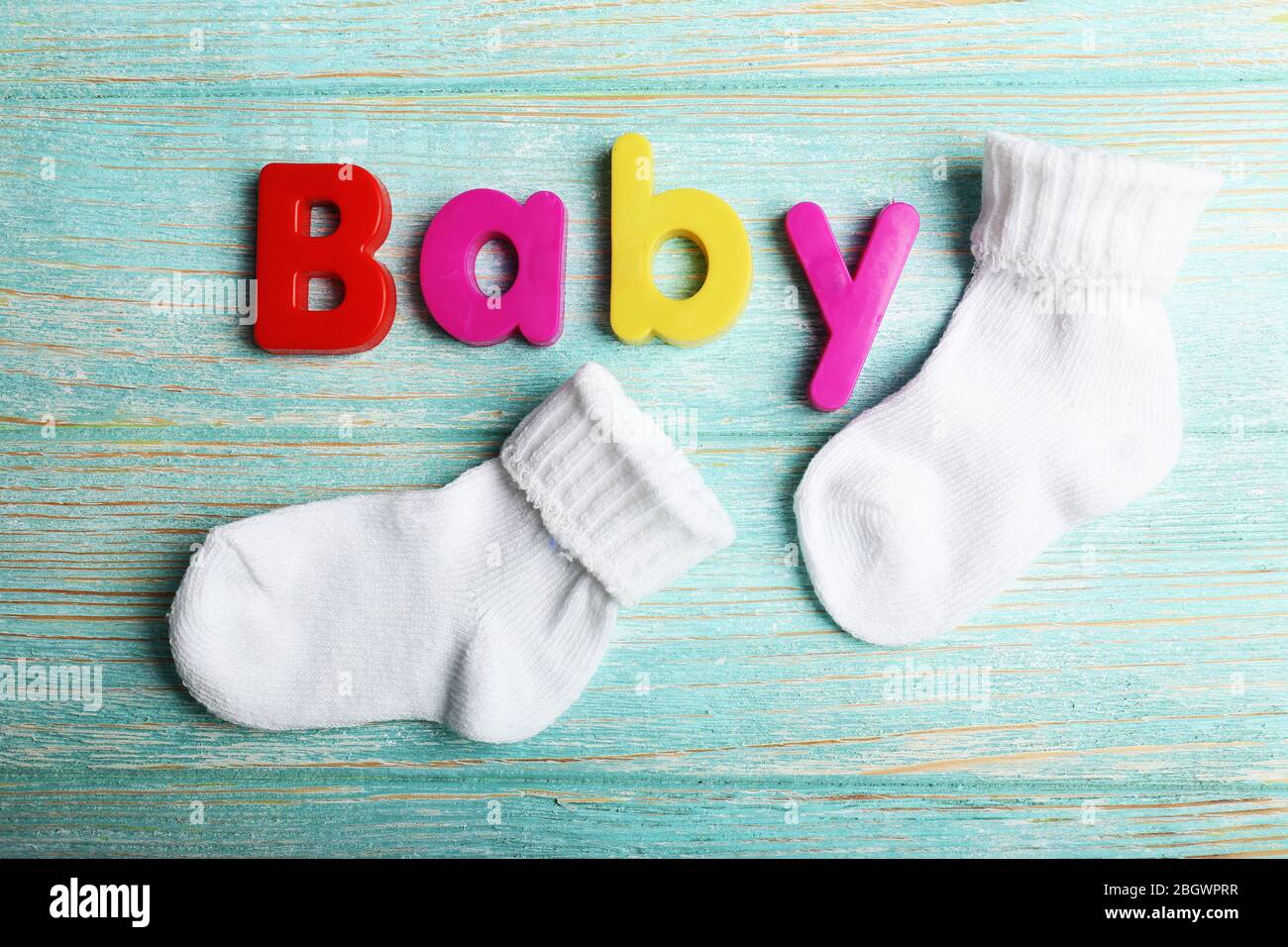 Baby word formed with colorful letters on wooden background Stock Photo ...