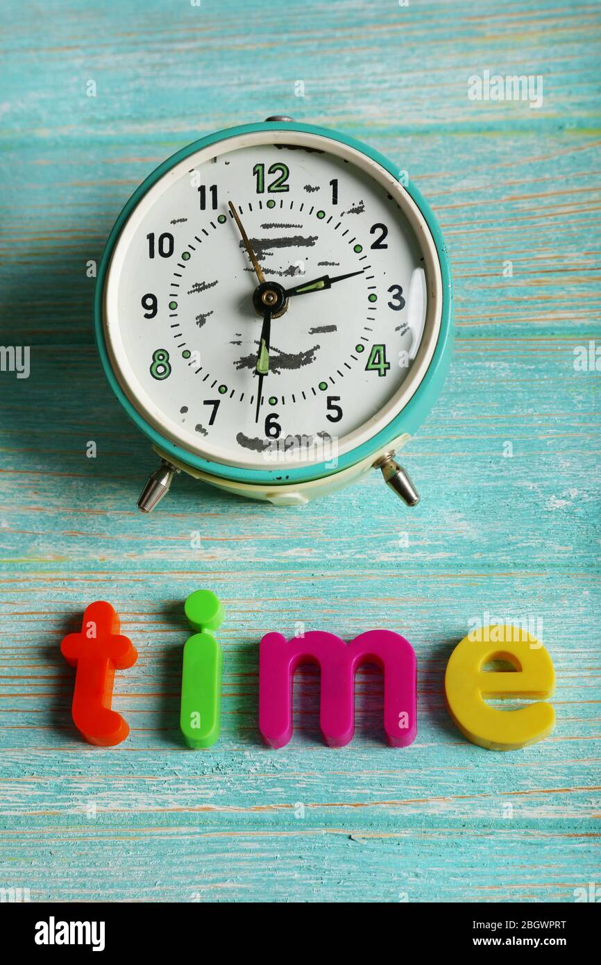 Time word formed with colorful letters on wooden background Stock Photo ...
