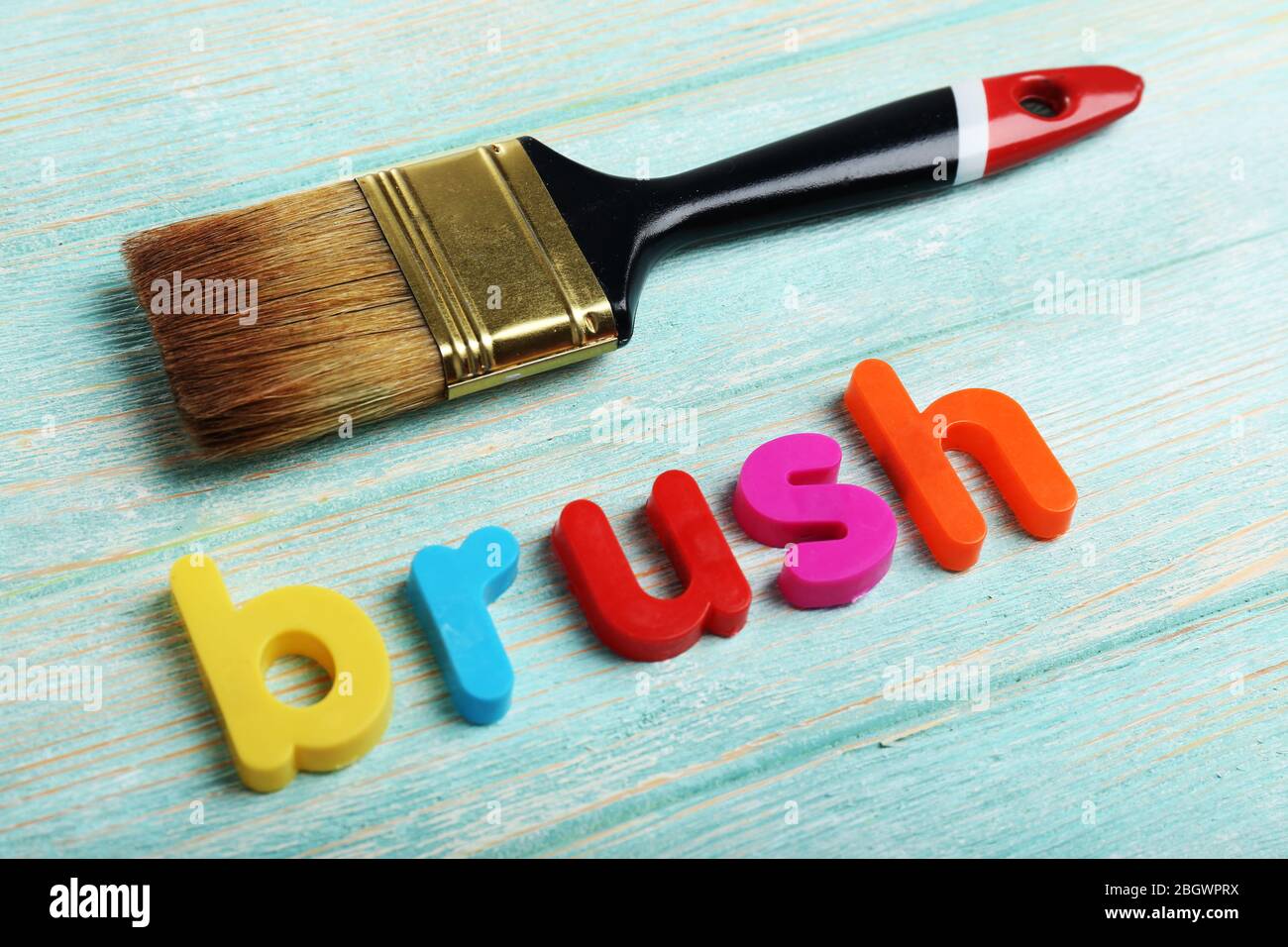 Brush word formed with colorful letters on wooden background Stock ...