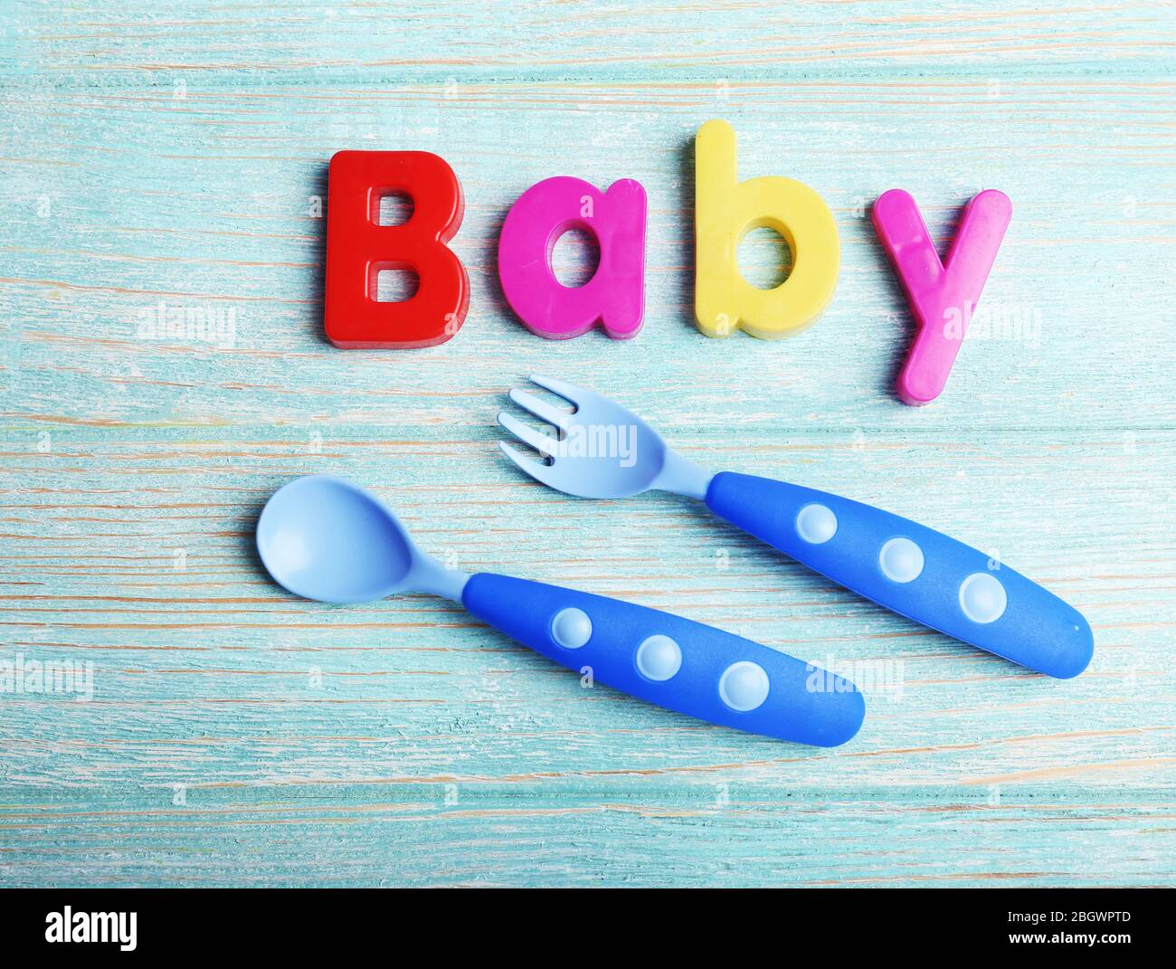 Baby word formed with colorful letters on wooden background Stock Photo ...