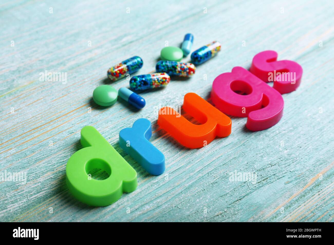 Drugs word formed with colorful letters on wooden background Stock ...