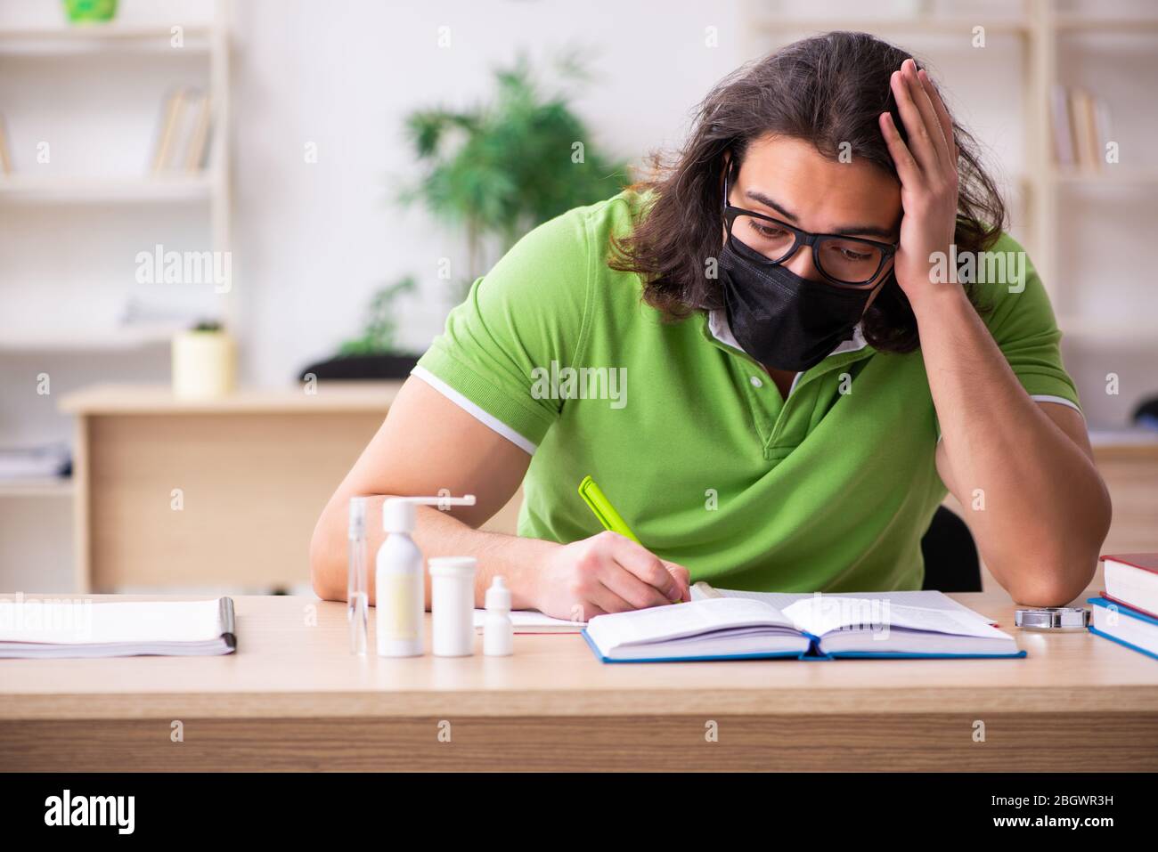 Young man student studying at the home in self-isolation concept Stock ...