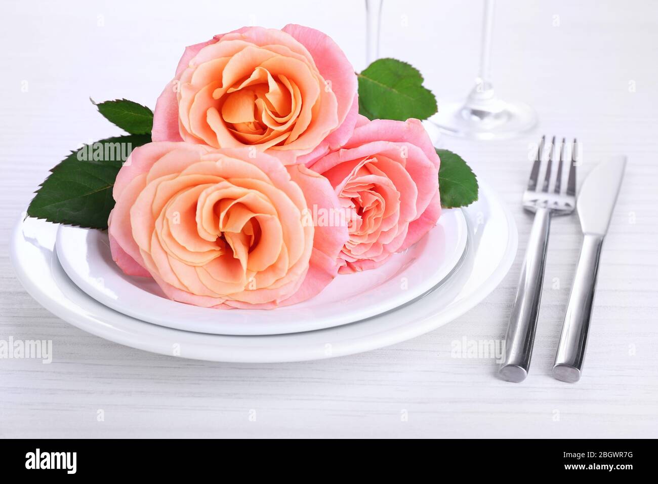 Table setting with pink rose on plate Stock Photo - Alamy