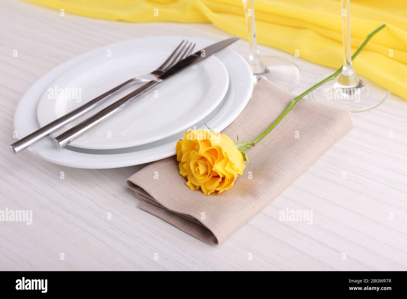 Table setting with yellow rose on plate Stock Photo - Alamy