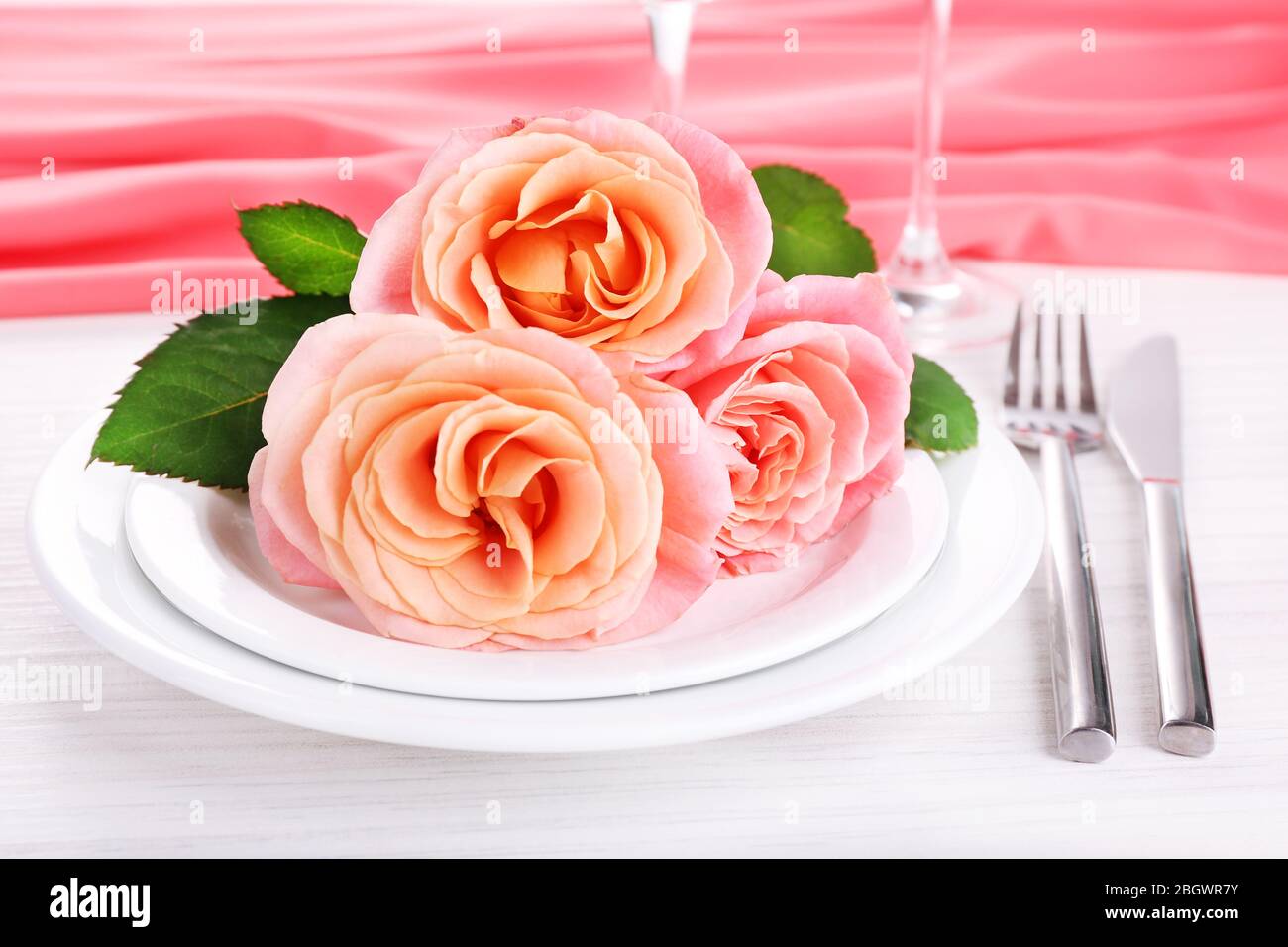 Table setting with pink rose on plate Stock Photo - Alamy