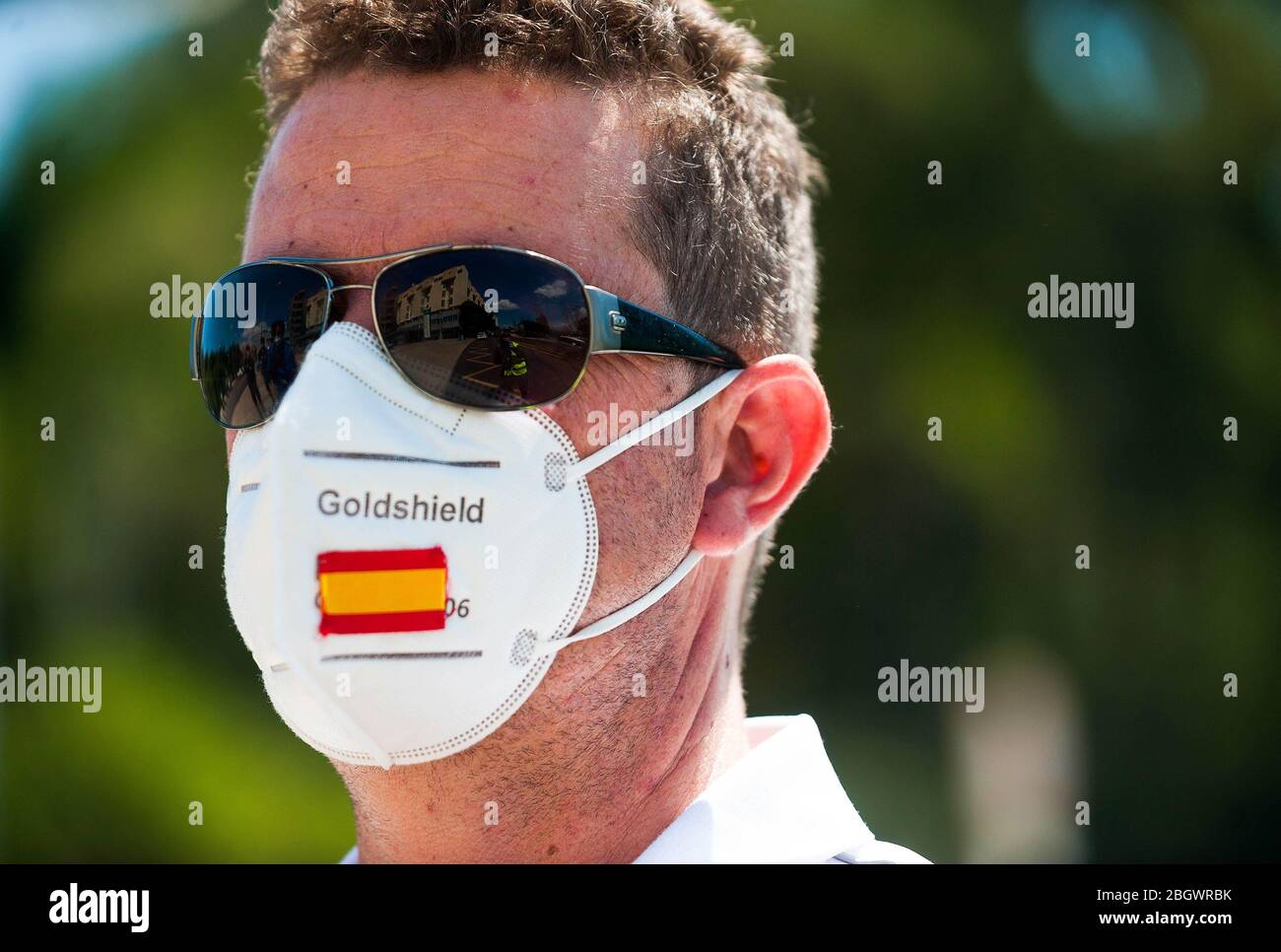 A taxi driver is seen posing for a photo wearing a face mask with a ...