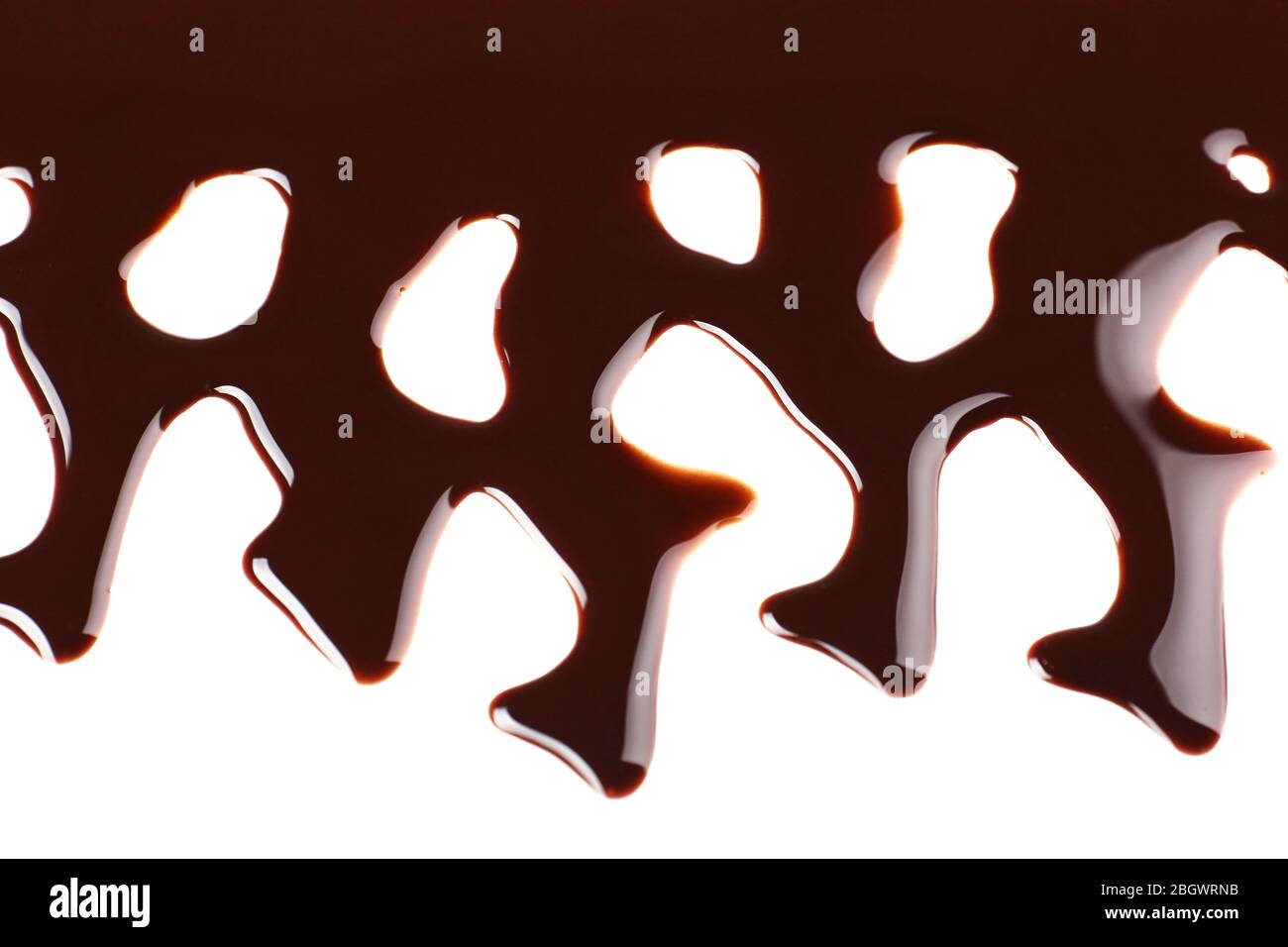 Melted chocolate dripping on white background Stock Photo - Alamy