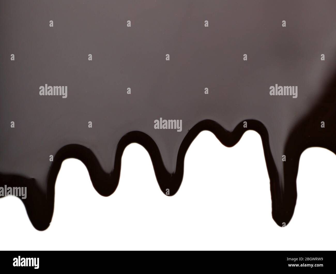 Melted chocolate dripping on white background Stock Photo - Alamy