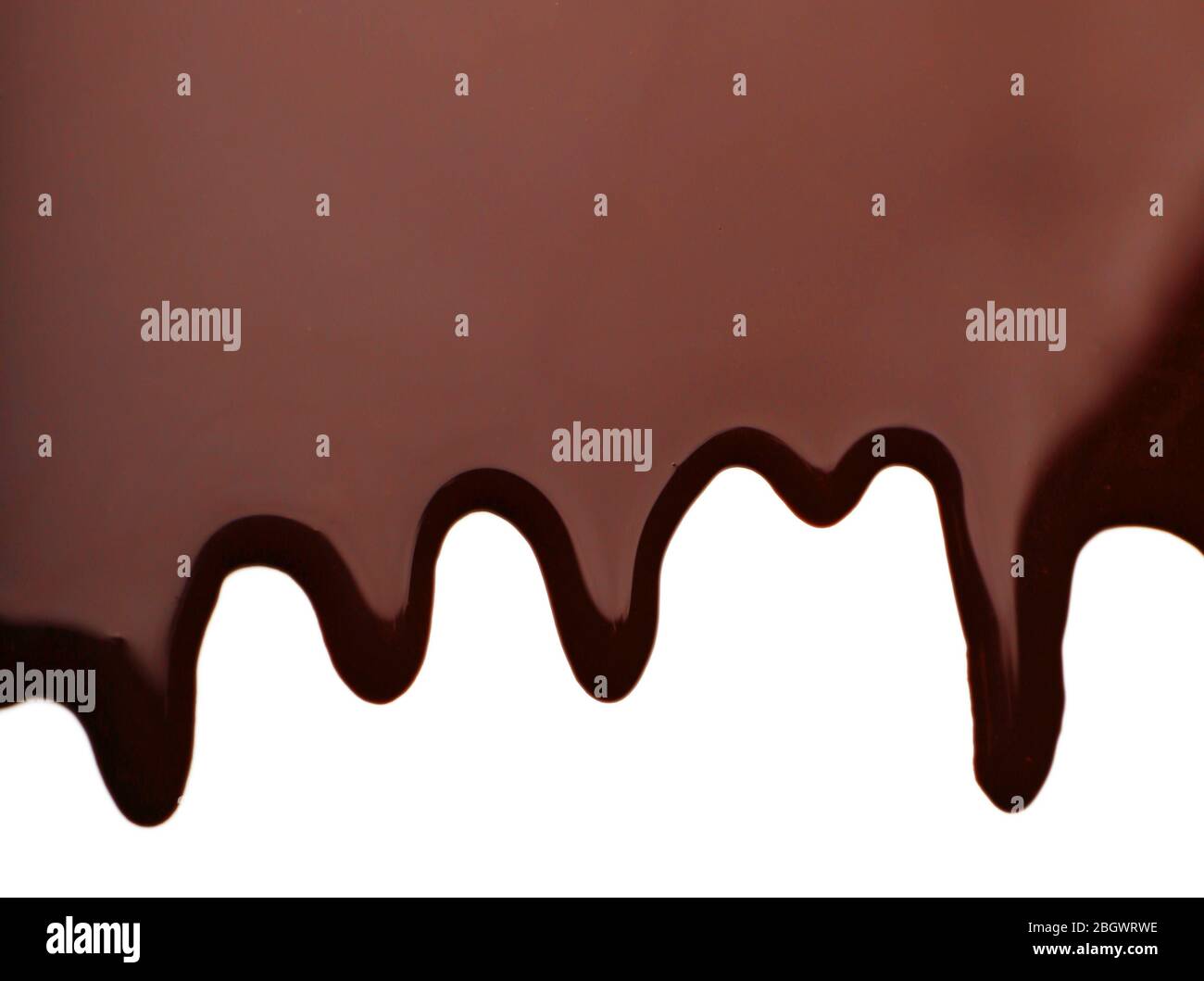 Melted chocolate dripping on white background Stock Photo - Alamy