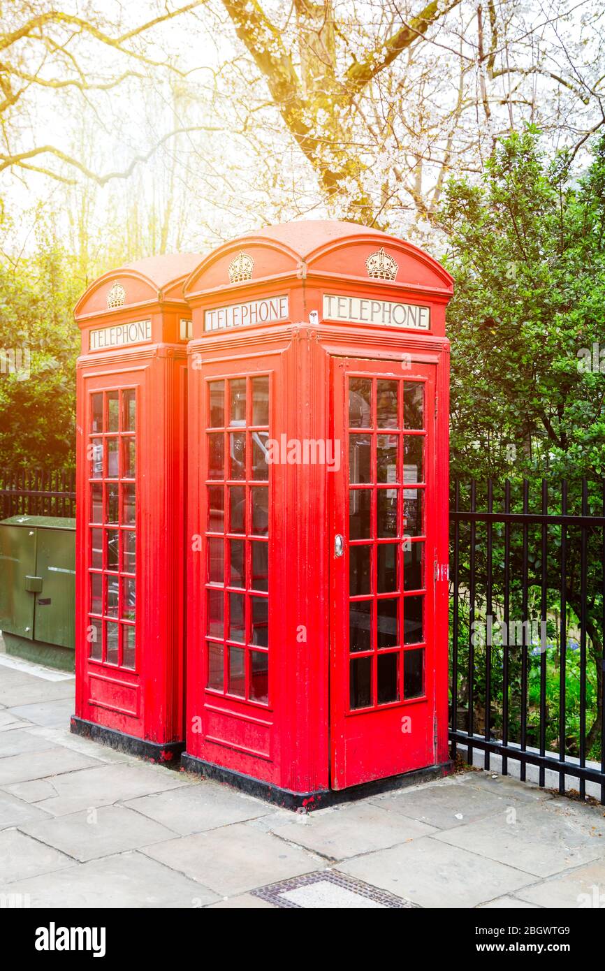 Red telephone box in street with historical architecture in London ...