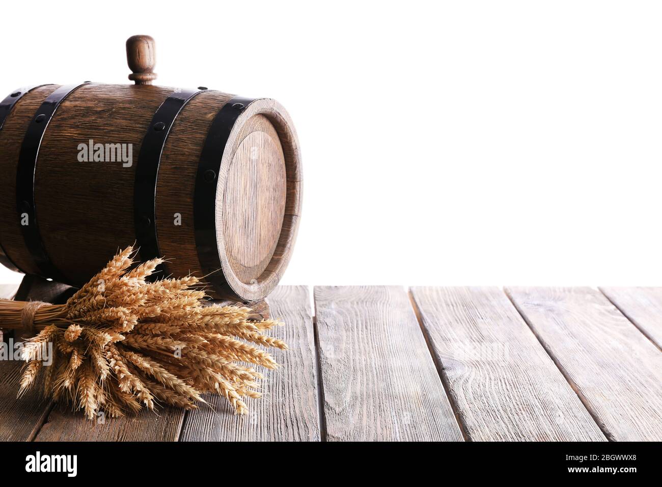 Old barrel with wheat on table on white background Stock Photo - Alamy