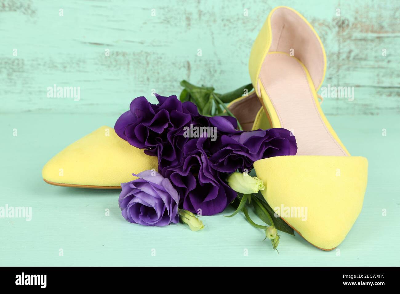 Beautiful woman shoes with flowers on wooden background Stock Photo - Alamy