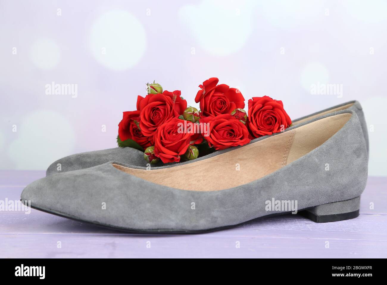 Beautiful woman shoes with flowers on bright background Stock Photo - Alamy