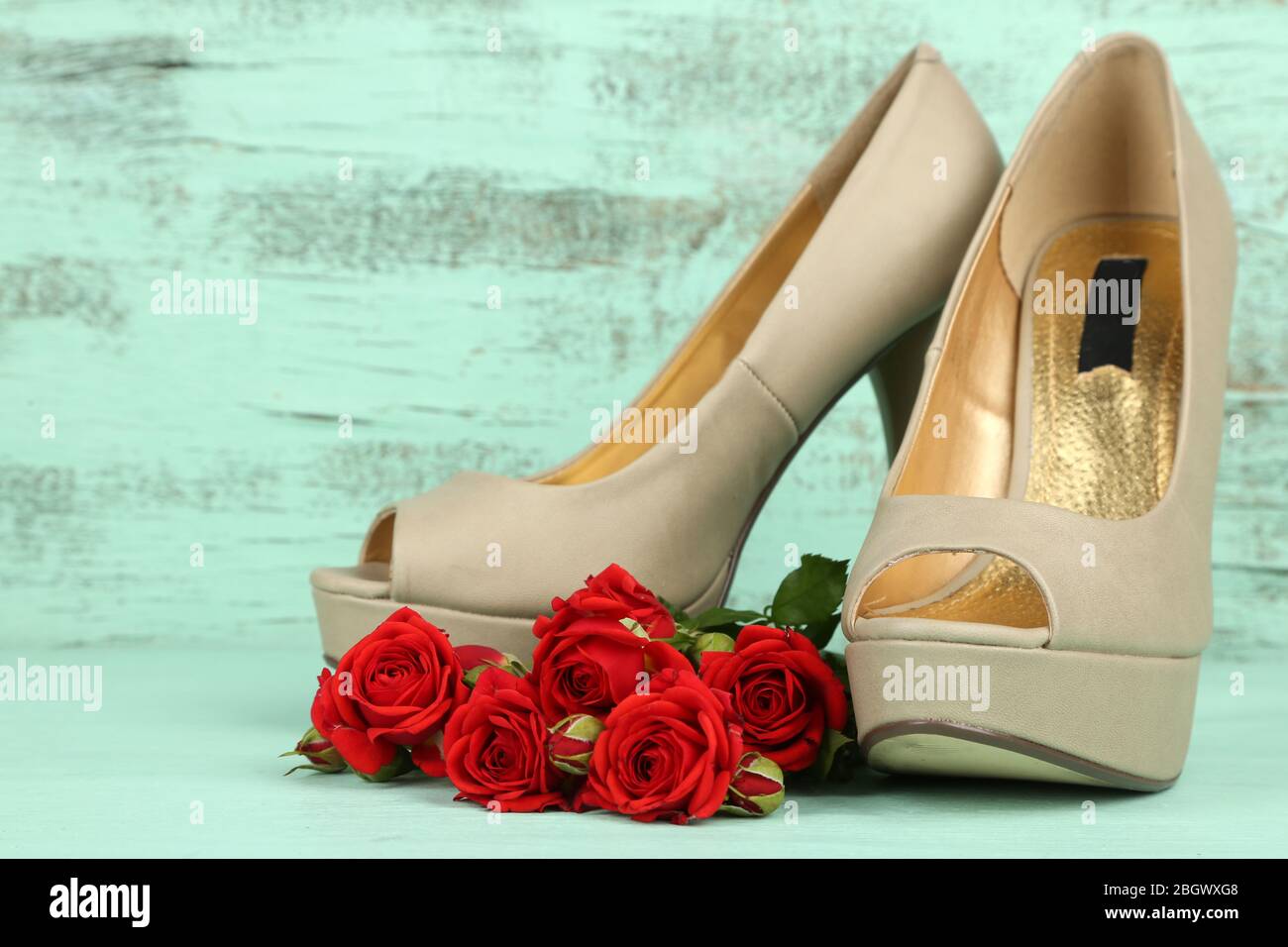 Beautiful woman shoes with flowers on wooden background Stock Photo - Alamy
