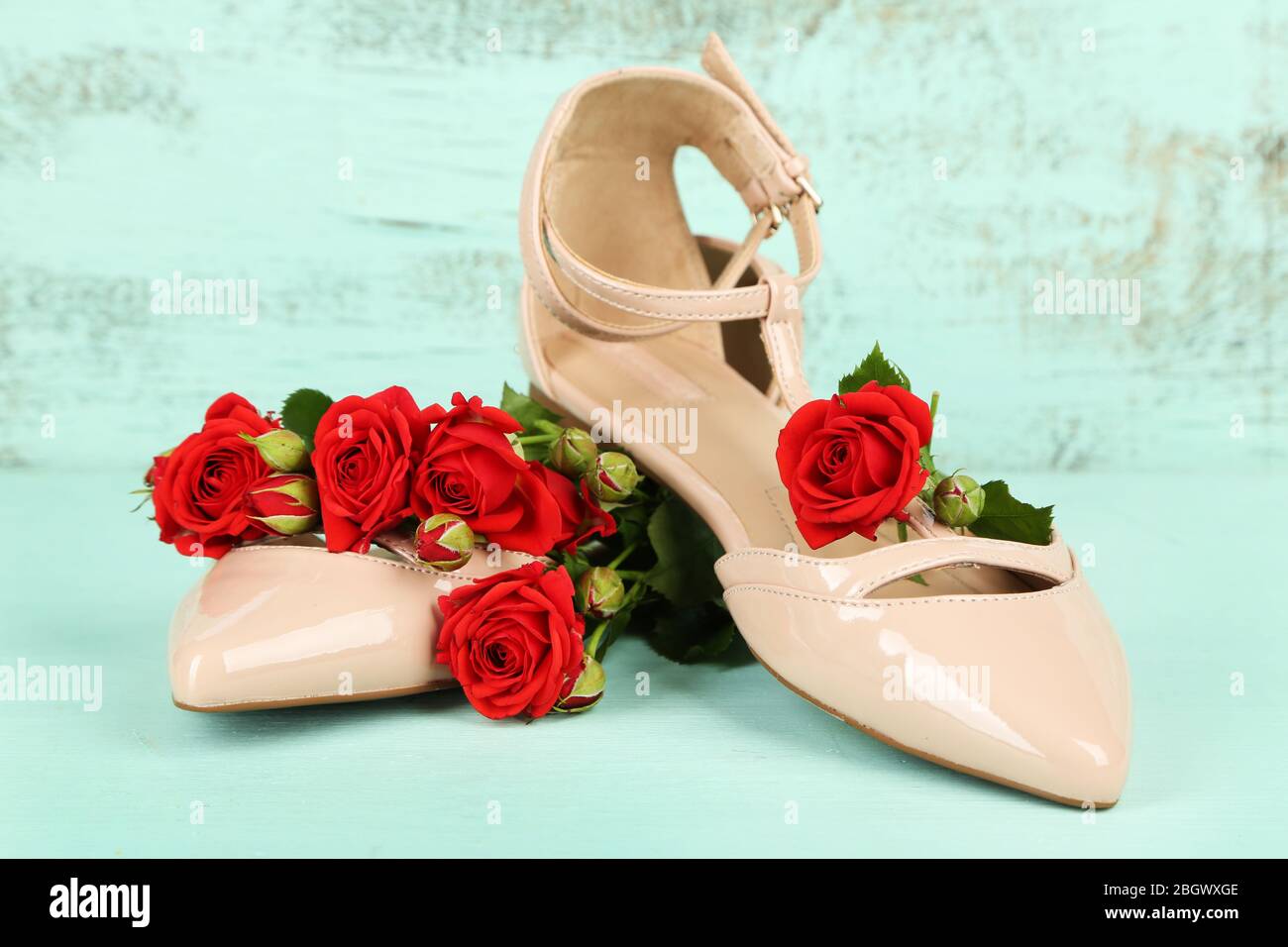 Beautiful woman shoes with flowers on wooden background Stock Photo - Alamy